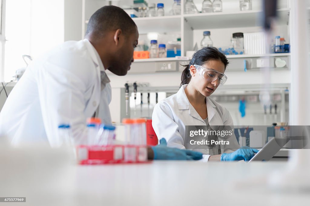 Scientists Discussing While Using Digital Tablet High-Res Stock Photo ... Scientists Discussing While Using Digital Tablet High-Res Stock Photo ...