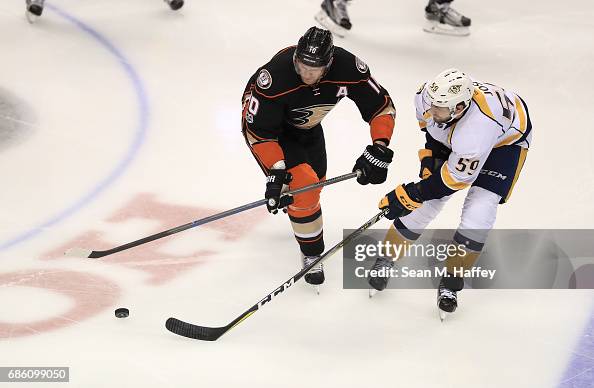 Roman Josi Of The Nashville Predators Plays The Puck From Corey Perry