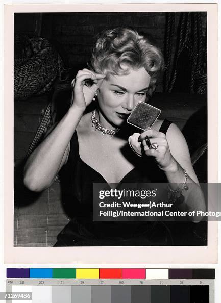 Hungarian Born American Actress Eva Gabor Adjusts Her Hair As She