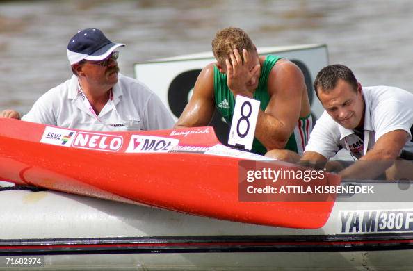Hungarian Attila Bozsik Holds His Head As Rescue Workers Lift His