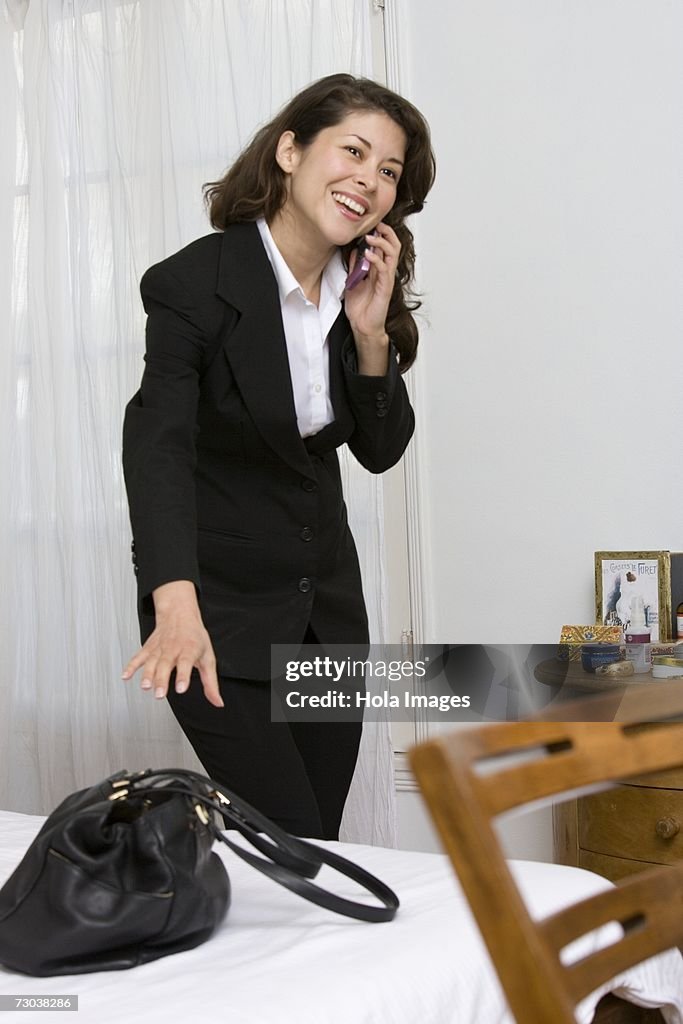 Young Woman Chatting On Cell Phone While Leaving For Work Photo Getty