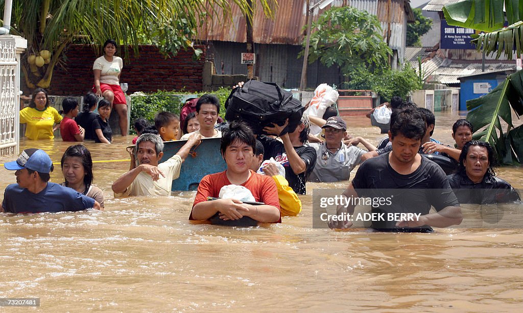 Floods Victims Wade Through Chest Deep Water As They Flee Their Homes