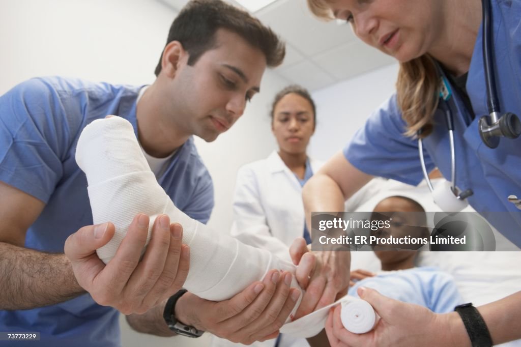 Doctors Wrapping African Boys Leg In Hospital High-Res Stock Photo ... Doctors Wrapping African Boys Leg In Hospital High-Res Stock Photo ...