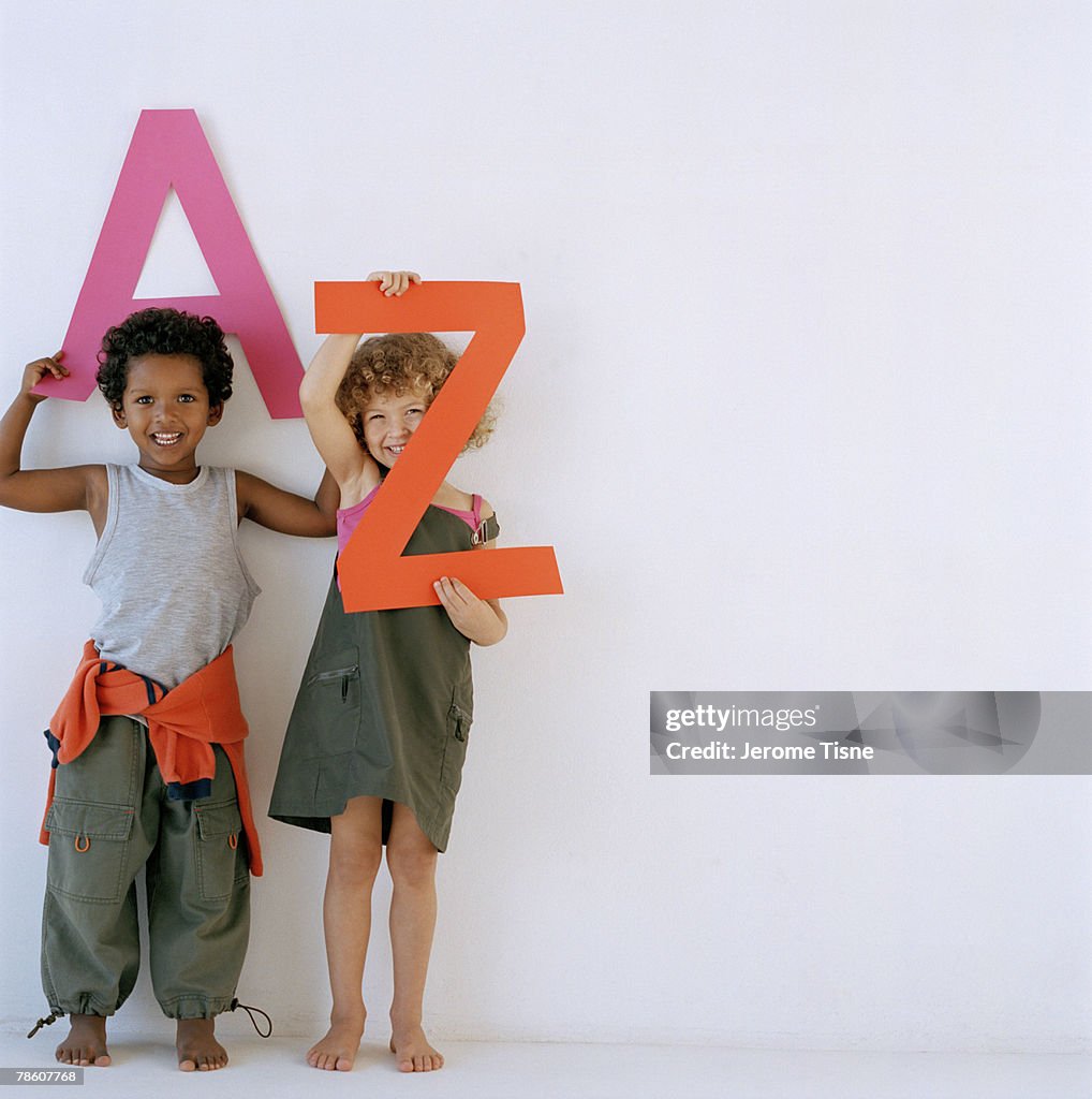 Boy And Girl Holding Colorful Letters High-Res Stock Photo - Getty Images Boy And Girl Holding Colorful Letters High-Res Stock Photo - Getty Images
