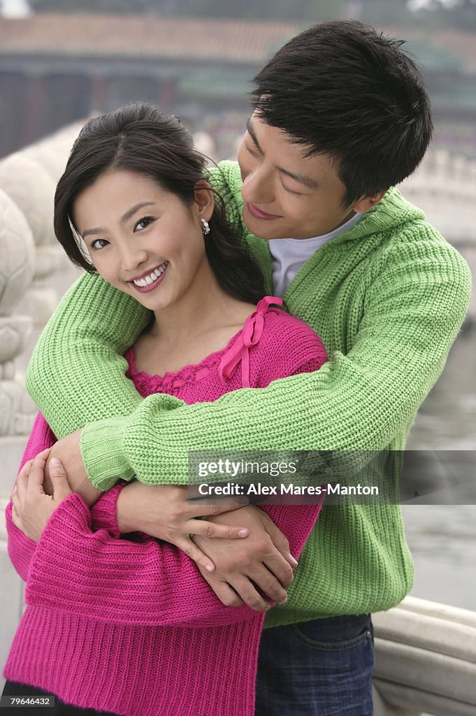 A Couple Smile As They Have Their Arms Around Each Other High Res Stock
