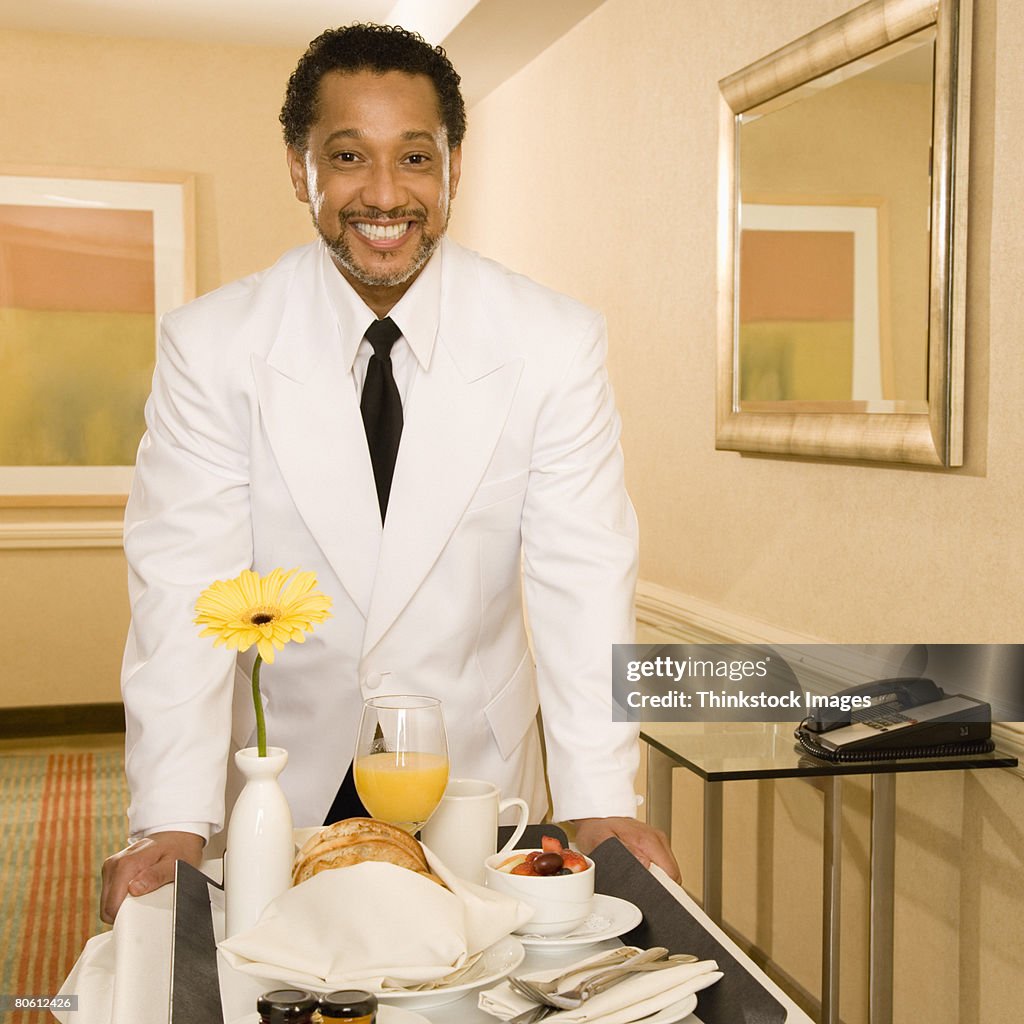 Smiling Room Service Waiter High-Res Stock Photo - Getty Images Smiling Room Service Waiter High-Res Stock Photo - Getty Images