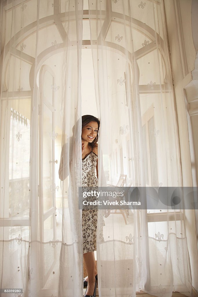Woman Peaking Through Curtains High-Res Stock Photo - Getty Images Woman Peaking Through Curtains High-Res Stock Photo - Getty Images