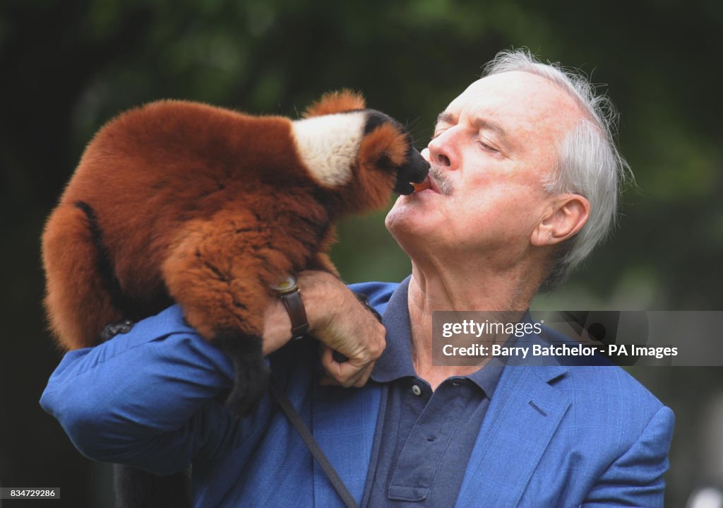 Monty Python star John Cleese feeds grapes to Colin the red ruffed ... Monty Python star John Cleese feeds grapes to Colin the red ruffed ...