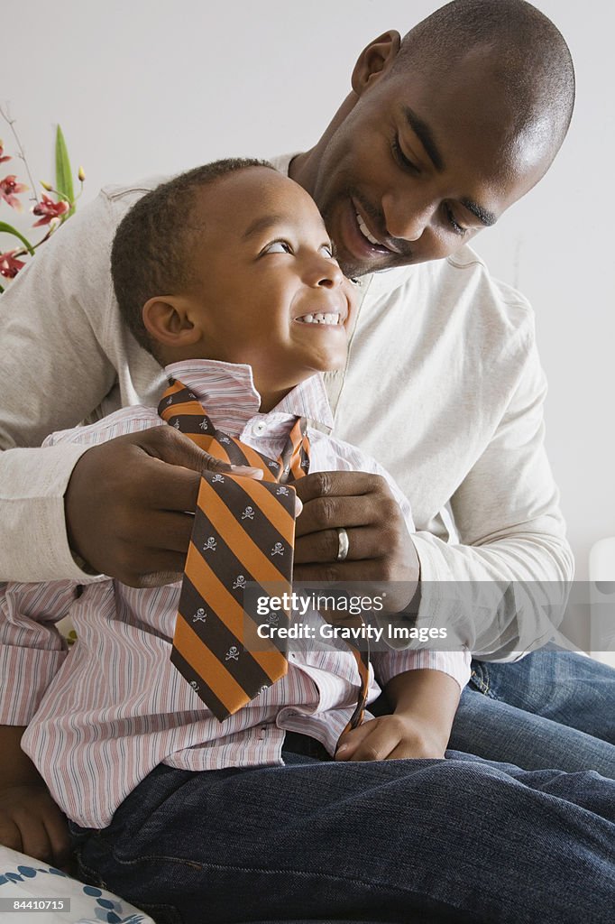Father Helping Son Put On Tie High-Res Stock Photo - Getty Images Father Helping Son Put On Tie High-Res Stock Photo - Getty Images