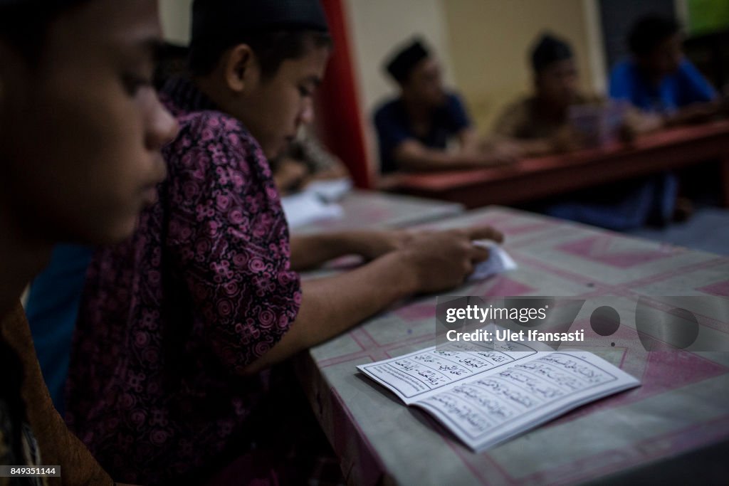 Recovering Drug Addicts Reading Quran During A Prayer Session Led By