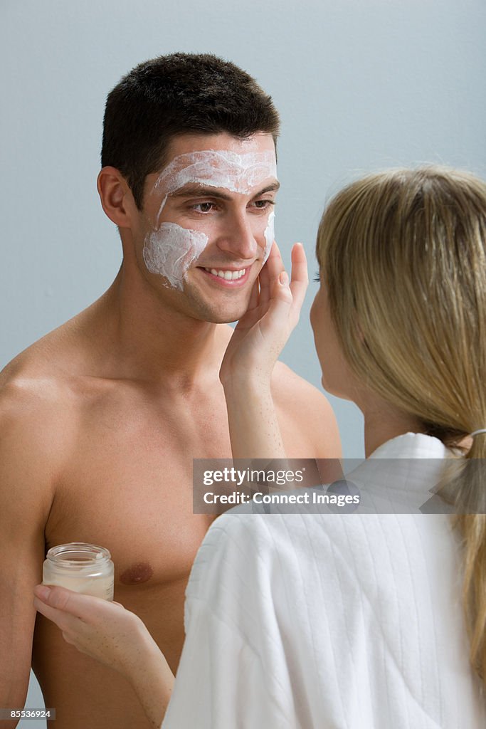 A Woman Applying Face Mask To A Mans Face High-Res Stock Photo - Getty ... A Woman Applying Face Mask To A Mans Face High-Res Stock Photo - Getty ...