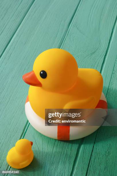 One large yellow rubber duck on a safety inflatable life ring near a ...