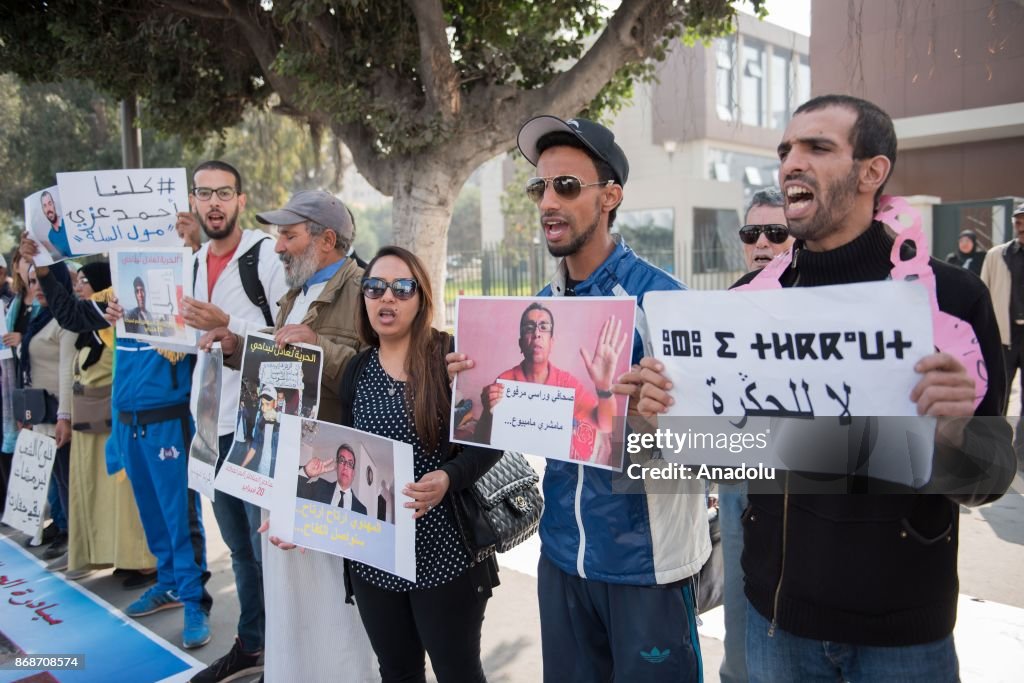 Activists And Relatives Of The Defendants Hold Banners During A News