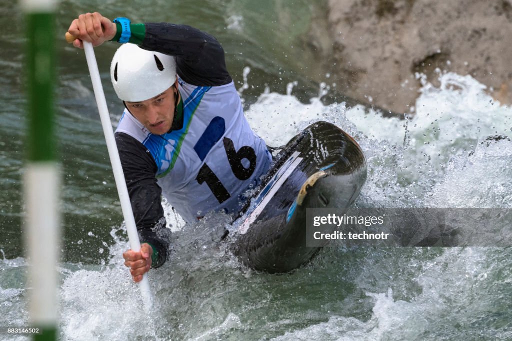 Front View Of Young Male Canoeist In The Whitewater Reaching The Green ... Front View Of Young Male Canoeist In The Whitewater Reaching The Green ...