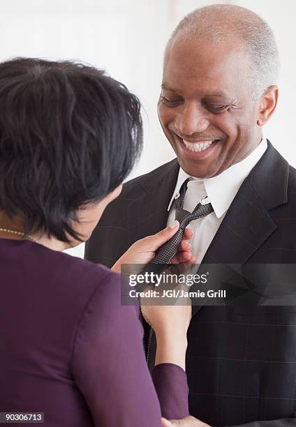 21 Middle Aged Black Man Smiling And Fixing His Tie Stock Photos, High ... 21 Middle Aged Black Man Smiling And Fixing His Tie Stock Photos, High ...