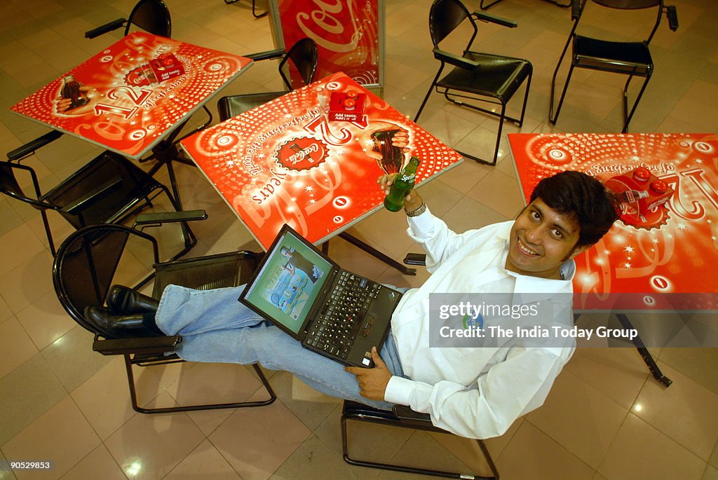 Debabrata Mukherjee, Director , Coca-Cola India , poses with laptop ... Debabrata Mukherjee, Director , Coca-Cola India , poses with laptop ...