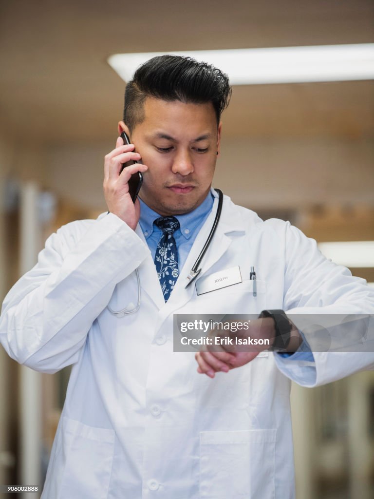 Filipino Doctor Talking On Cell Phone And Checking The Time High-Res ... Filipino Doctor Talking On Cell Phone And Checking The Time High-Res ...