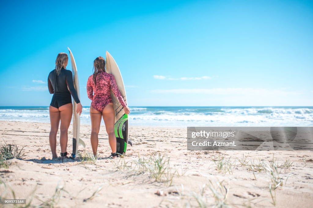 Surfer Girls Holding Their Surfboards On The Beach In Australia High