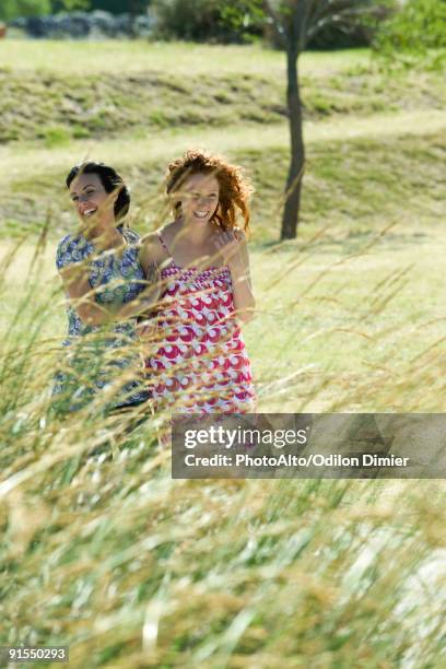 Women Walking Through Tall Grass Photos And Premium High Res Pictures