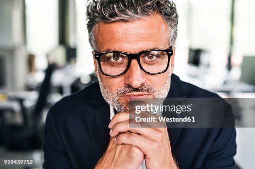 Portrait Of Serious Mature Businessman Wearing Glasses In Office High