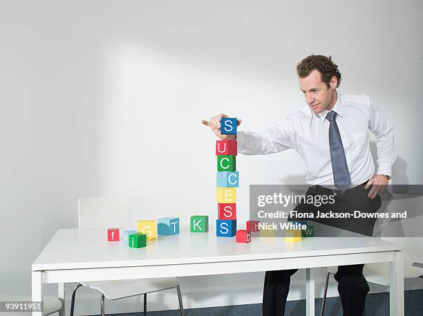 Man Stacking Blocks Photos And Premium High Res Pictures Getty Images
