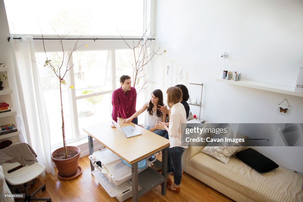 Business Colleagues Having Discussion Over Laptop At Table High-Res ... Business Colleagues Having Discussion Over Laptop At Table High-Res ...
