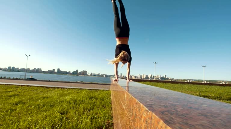 Young Caucasian Female Cheerleader Walking On Handstand Outdoors At Sunny 동영상 981814196 게티이미지뱅크