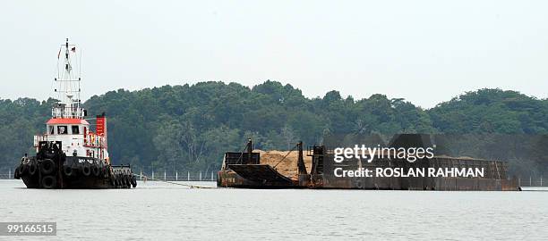 A tug-boat tows a barge filled with sand along Johor Straits,... News ... A tug-boat tows a barge filled with sand along Johor Straits,... News ...