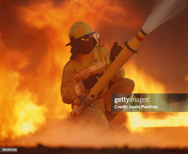 Firefighter Putting Out Fire Photos and Premium High Res Pictures ... Firefighter Putting Out Fire Photos and Premium High Res Pictures ...