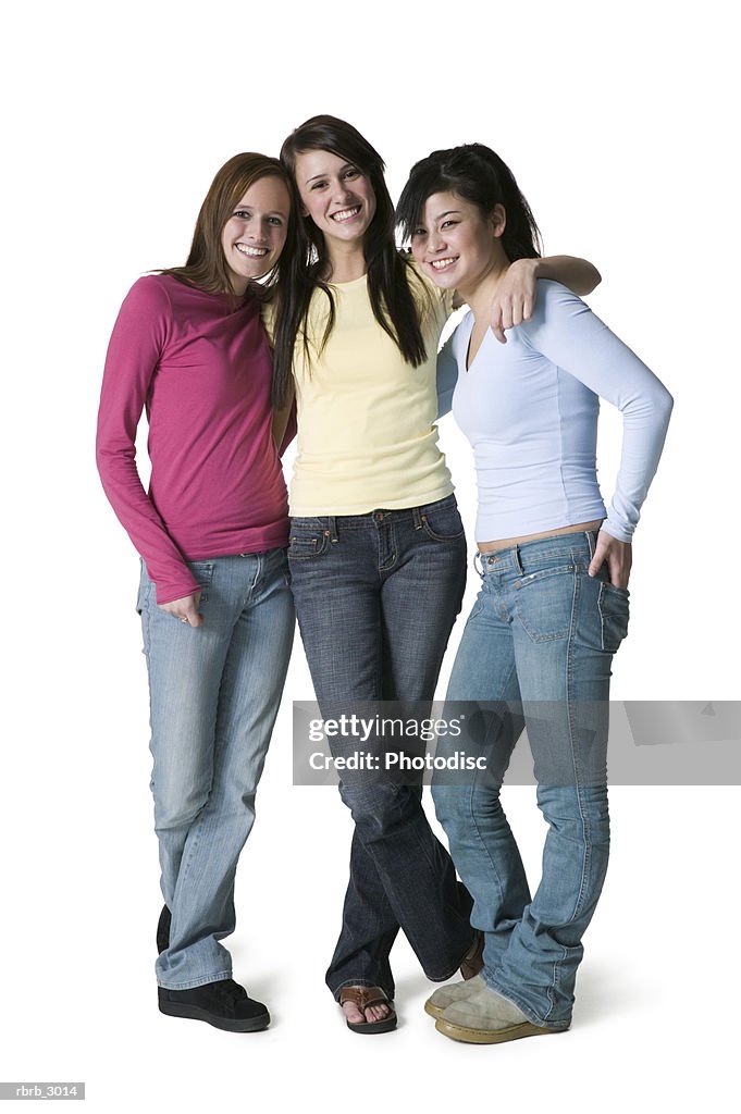 Portrait Of Three Teenage Girls Standing Together Smiling High Res