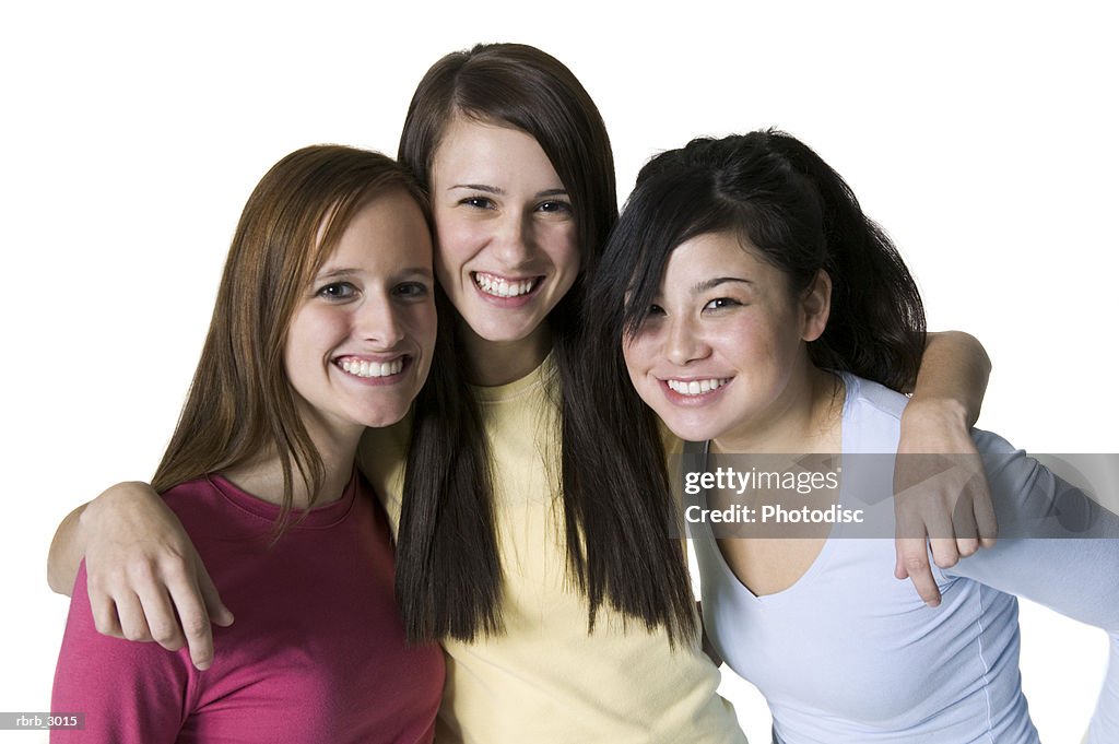 Portrait Of Three Teenage Girls Standing Together Smiling High Res