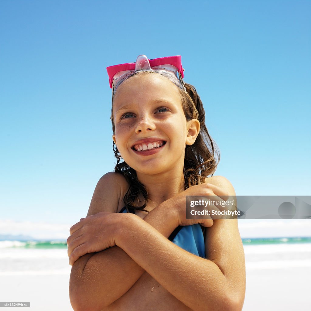 Low Angle View Of A Girl Smiling Shivering On The Beach High Res Stock